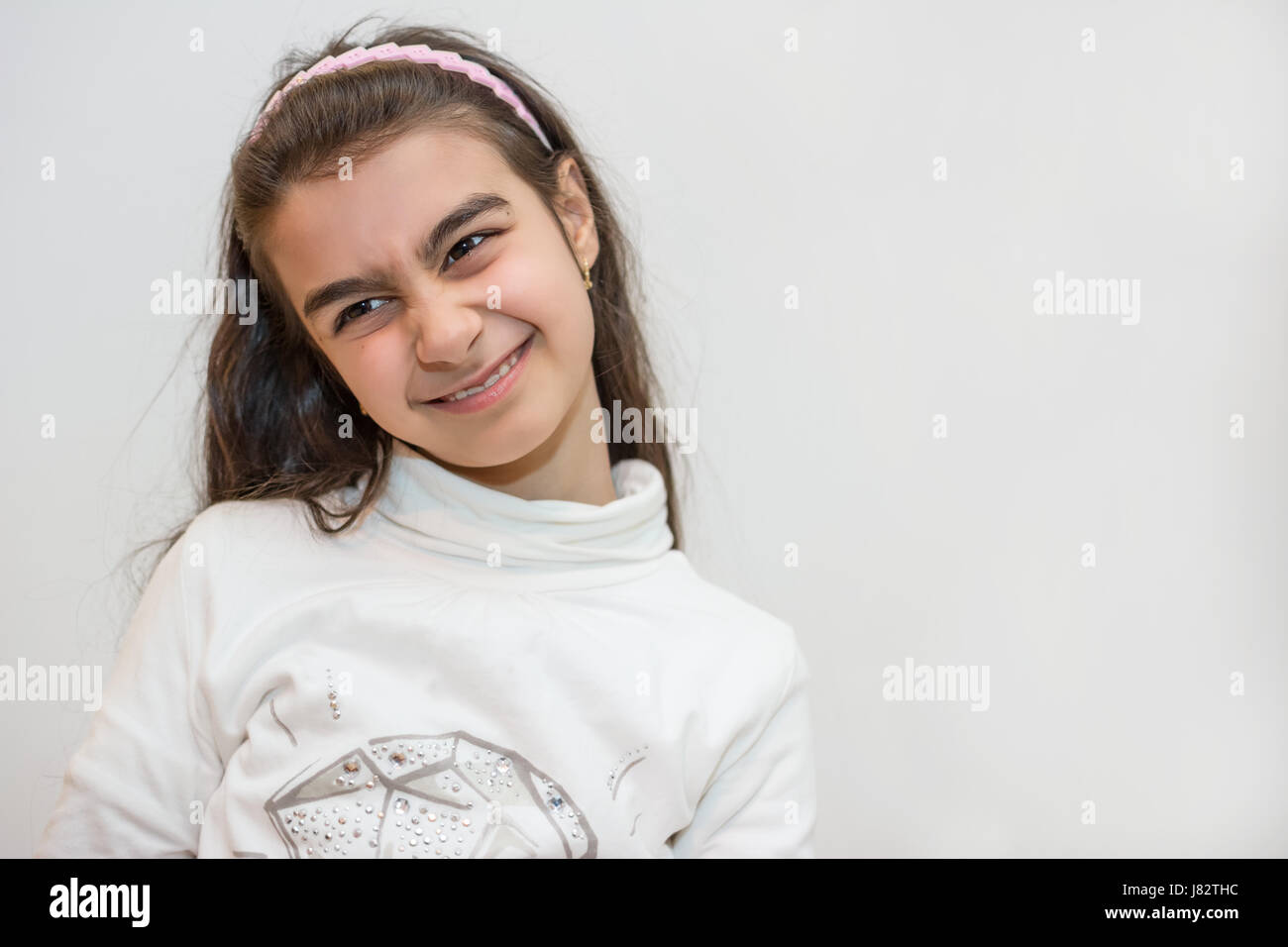 Portrait of young little girl with a grimace with curled nose Stock ...