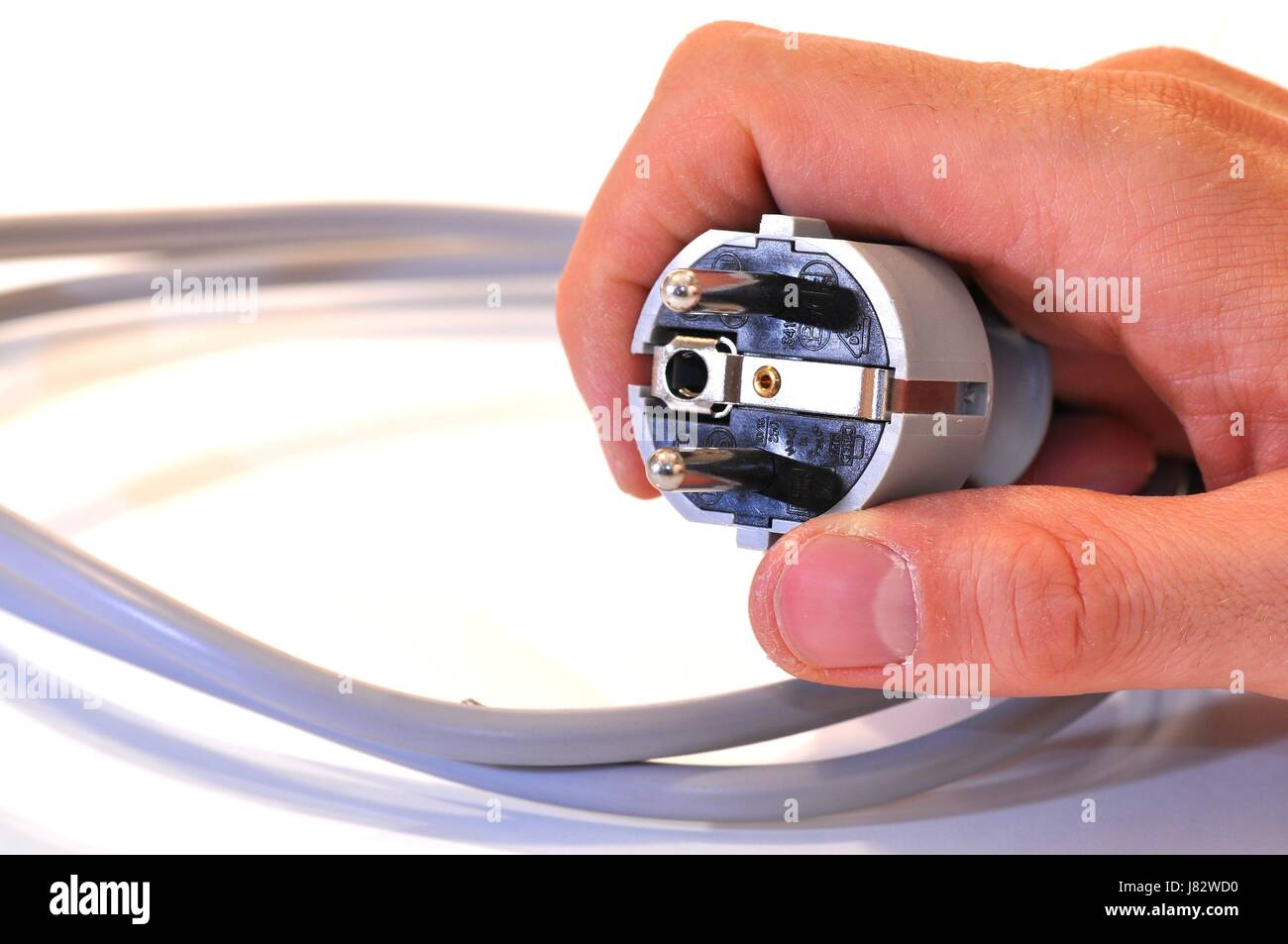 power plug in hand Stock Photo - Alamy