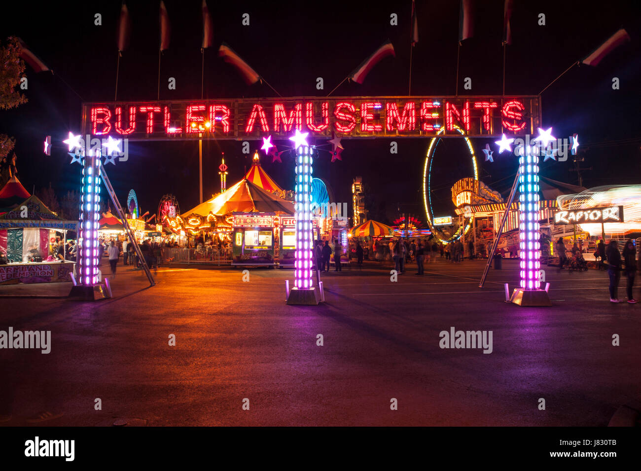 Evergreen State Fair with ferris wheel and game booths at night Stock ...