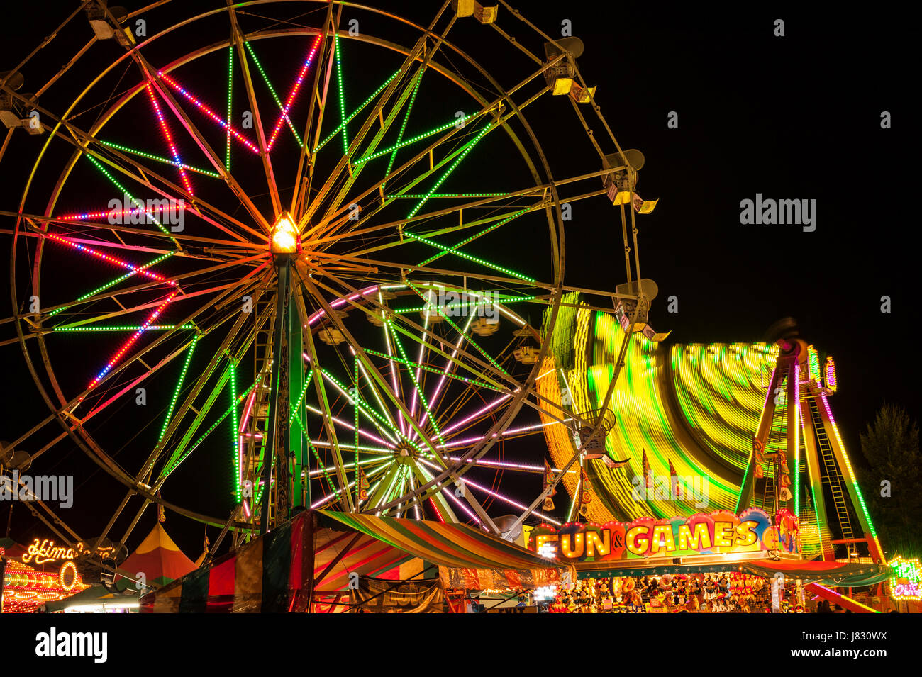 Evergreen State Fair with ferris wheel and game booths at night Stock ...