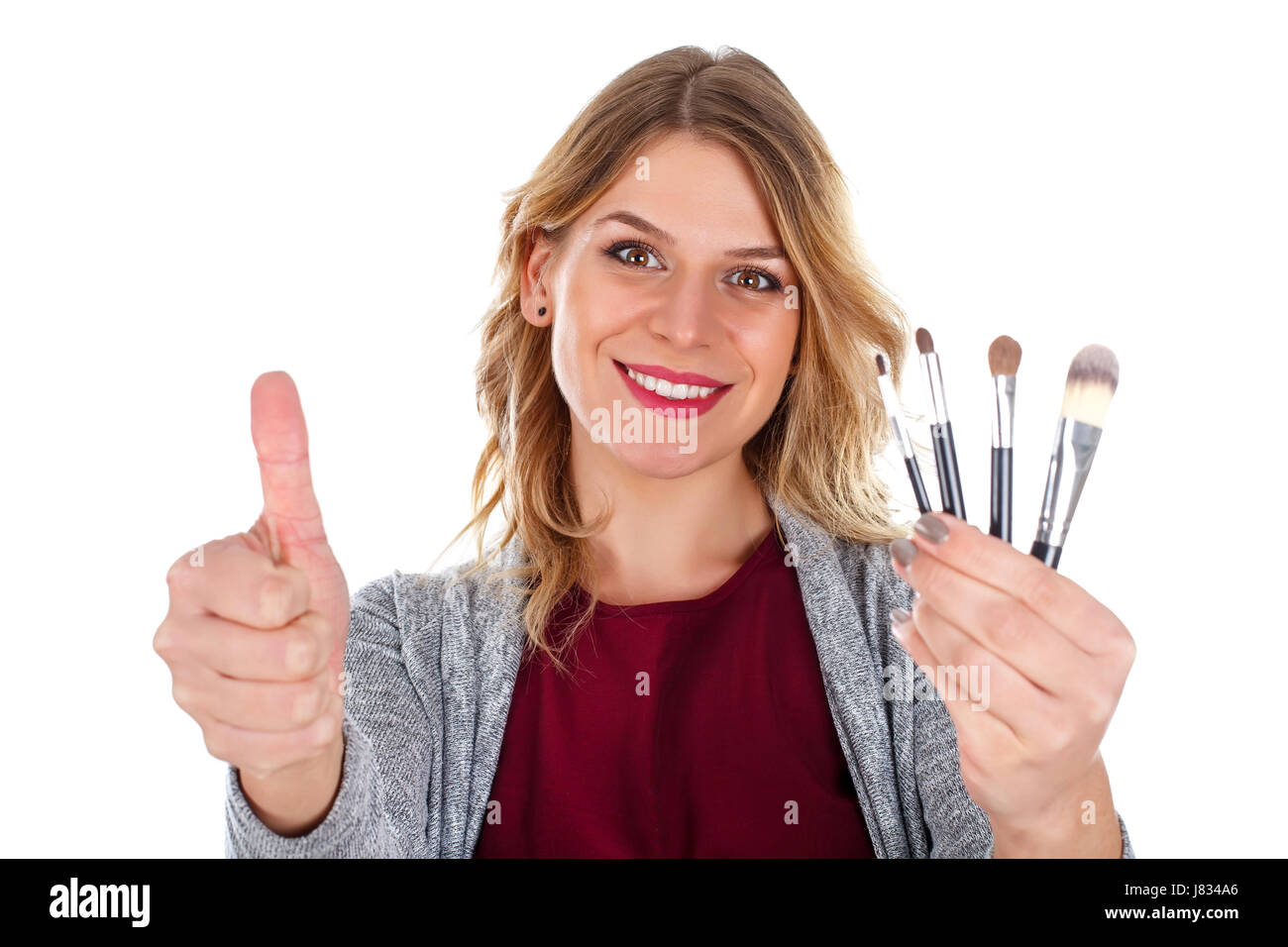 Picture of a beautiful make-up artist showing thumbs up Stock Photo - Alamy