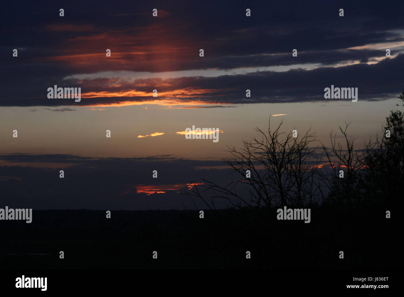 Fiery rays of the sun in the sky with colorful clouds at sunset Stock ...