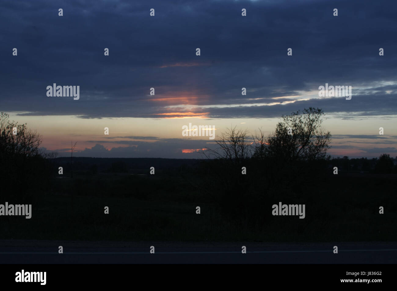 Fiery rays of the sun in the sky with colorful clouds at sunset Stock ...