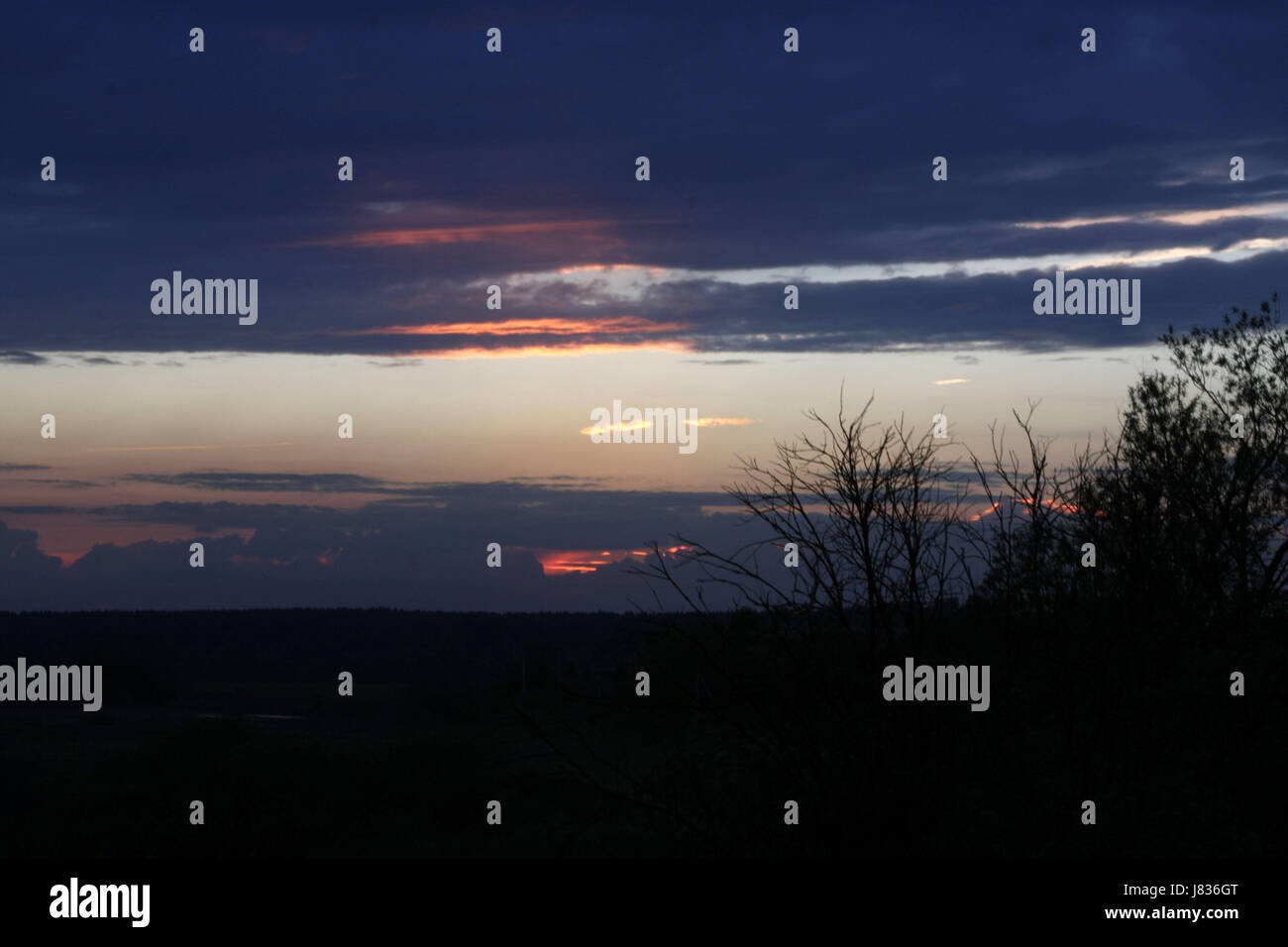 Fiery rays of the sun in the sky with colorful clouds at sunset Stock ...