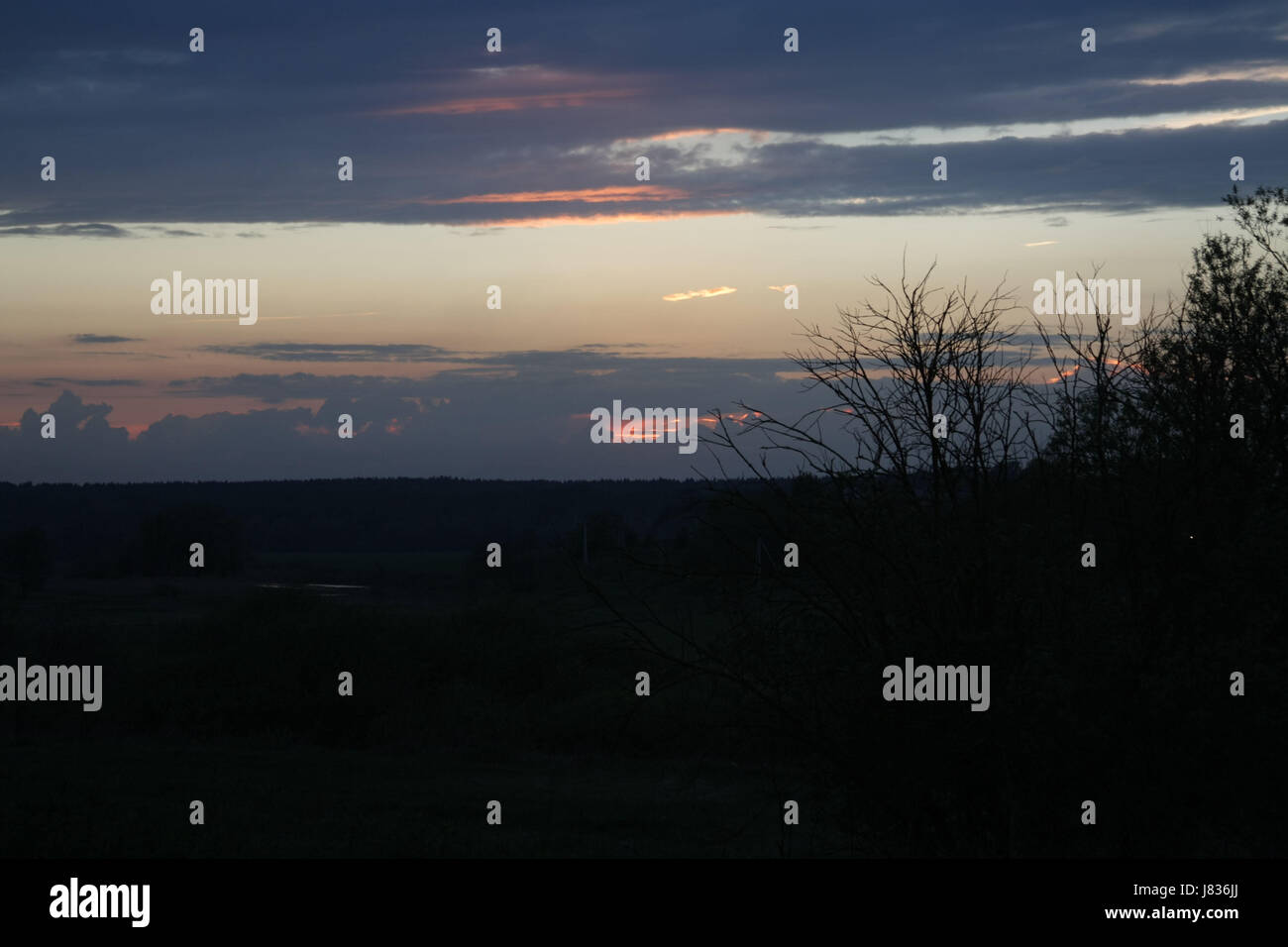 Fiery rays of the sun in the sky with colorful clouds at sunset Stock ...