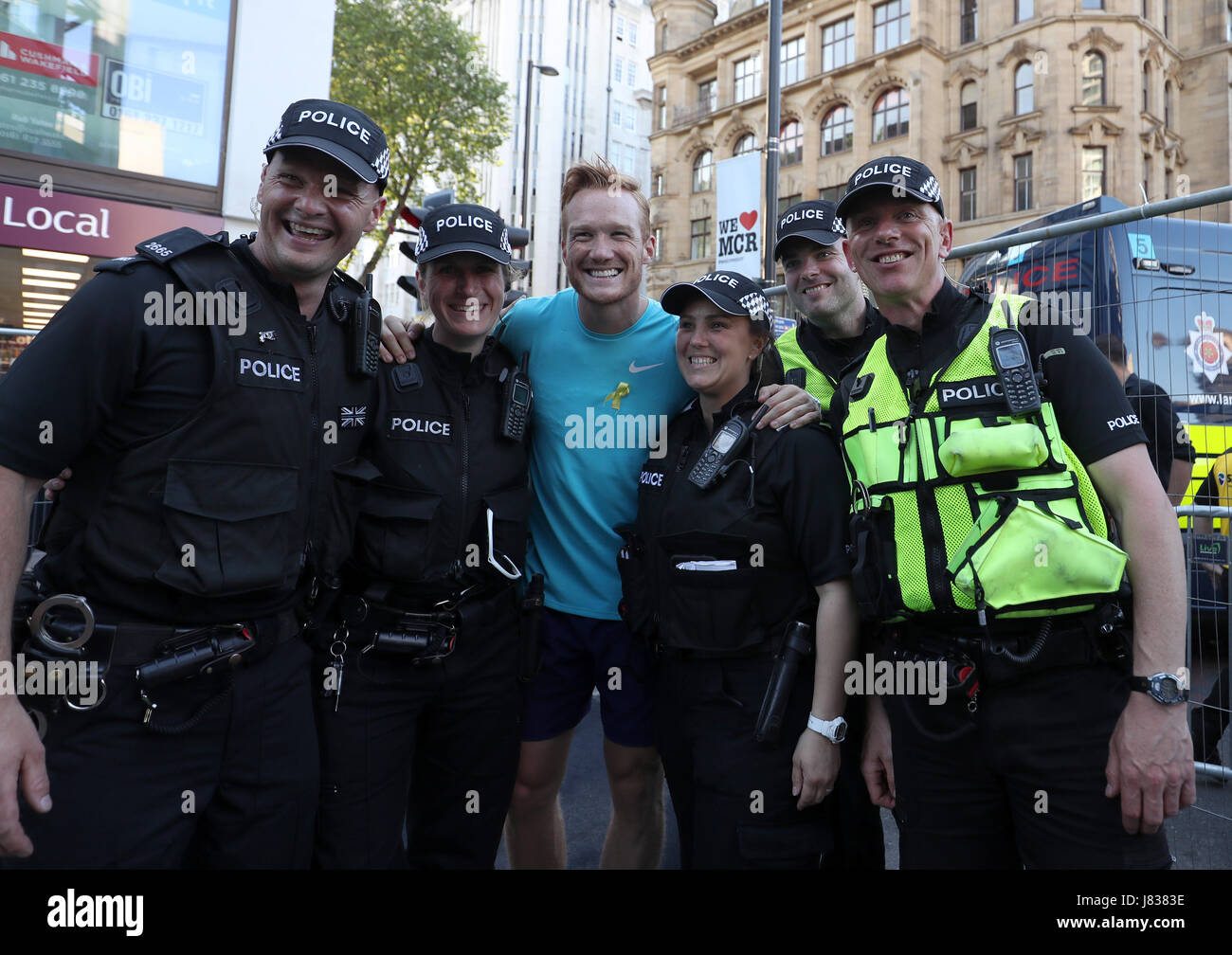 Athlete Greg Rutherford poses for a photograph with police during the ...