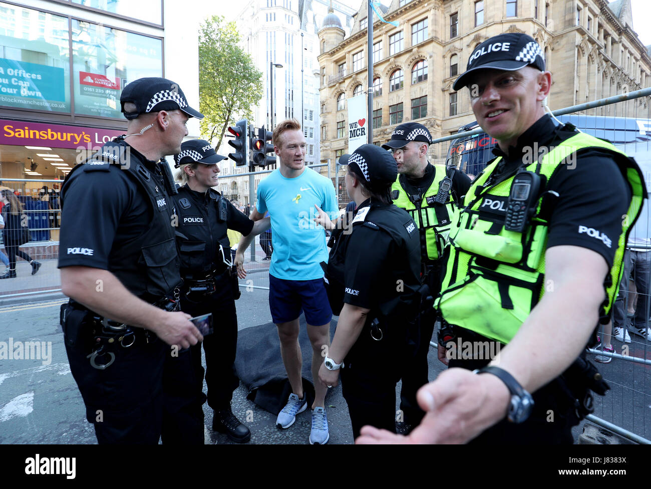 Athlete Greg Rutherford greets police during the Arcadis Great ...