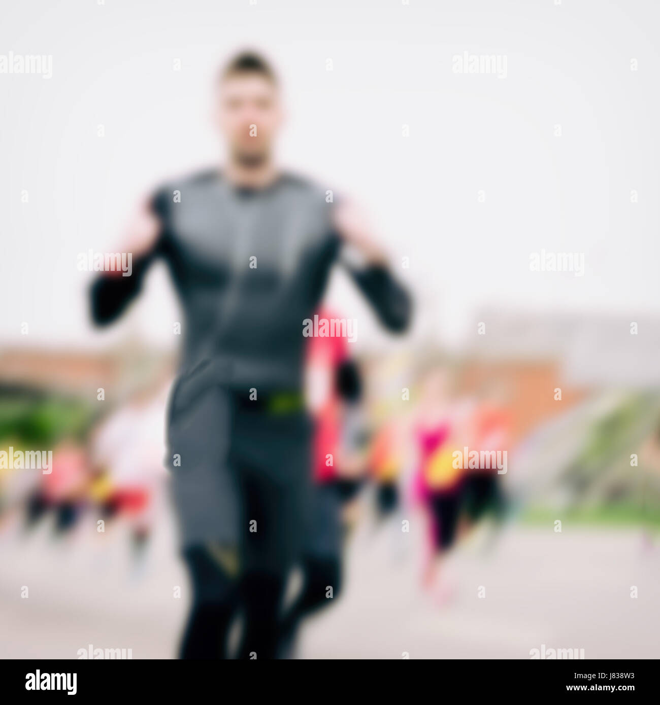 Happy winner athlete, young muscular man, coming first to finish and ...