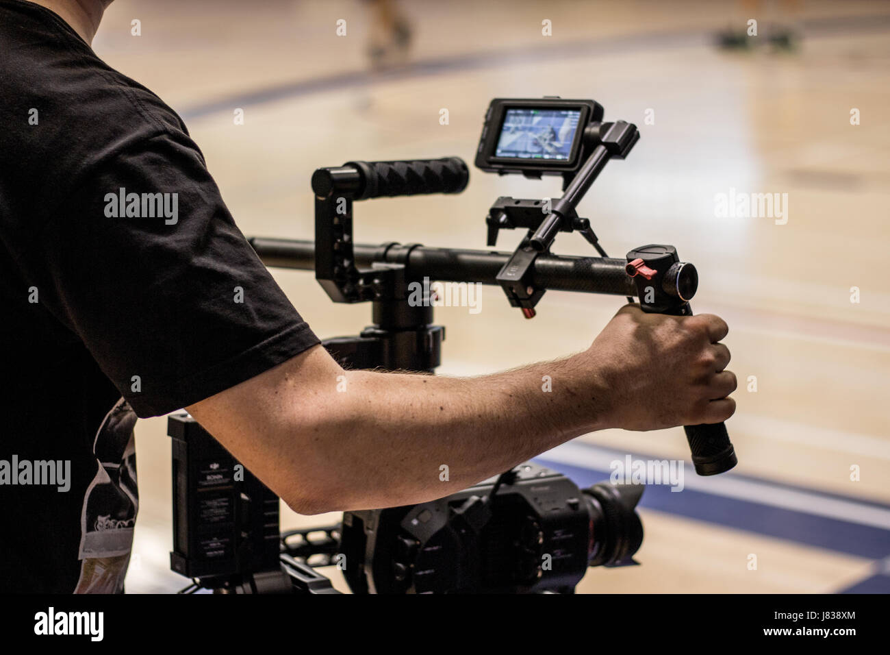 Filming in a school gym with a gimbal Stock Photo - Alamy