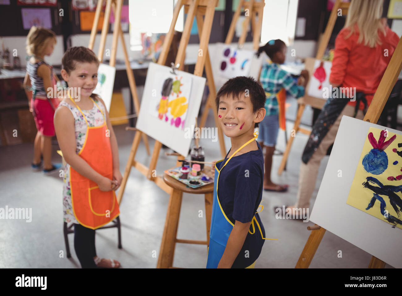 Portrait of happy schoolkids practicing drawing Stock Photo - Alamy