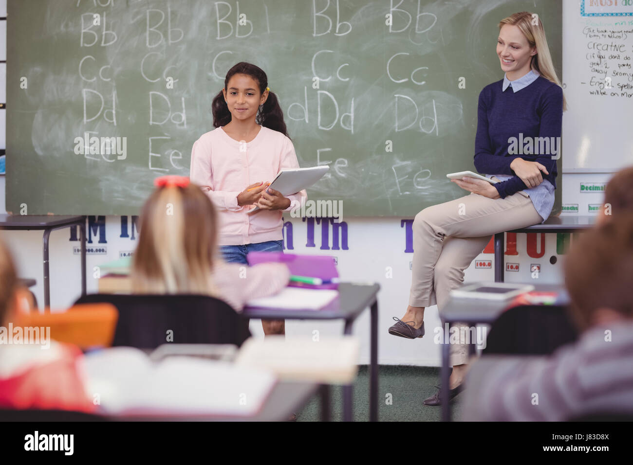 Schoolgirl taking lesson of her classmates in school Stock Photo - Alamy