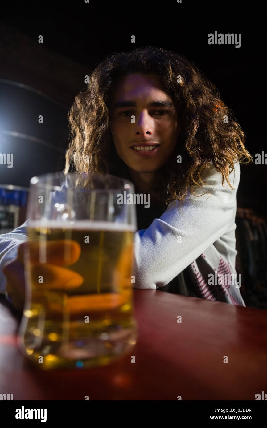 Portrait of man holding beer mug in bar Stock Photo - Alamy