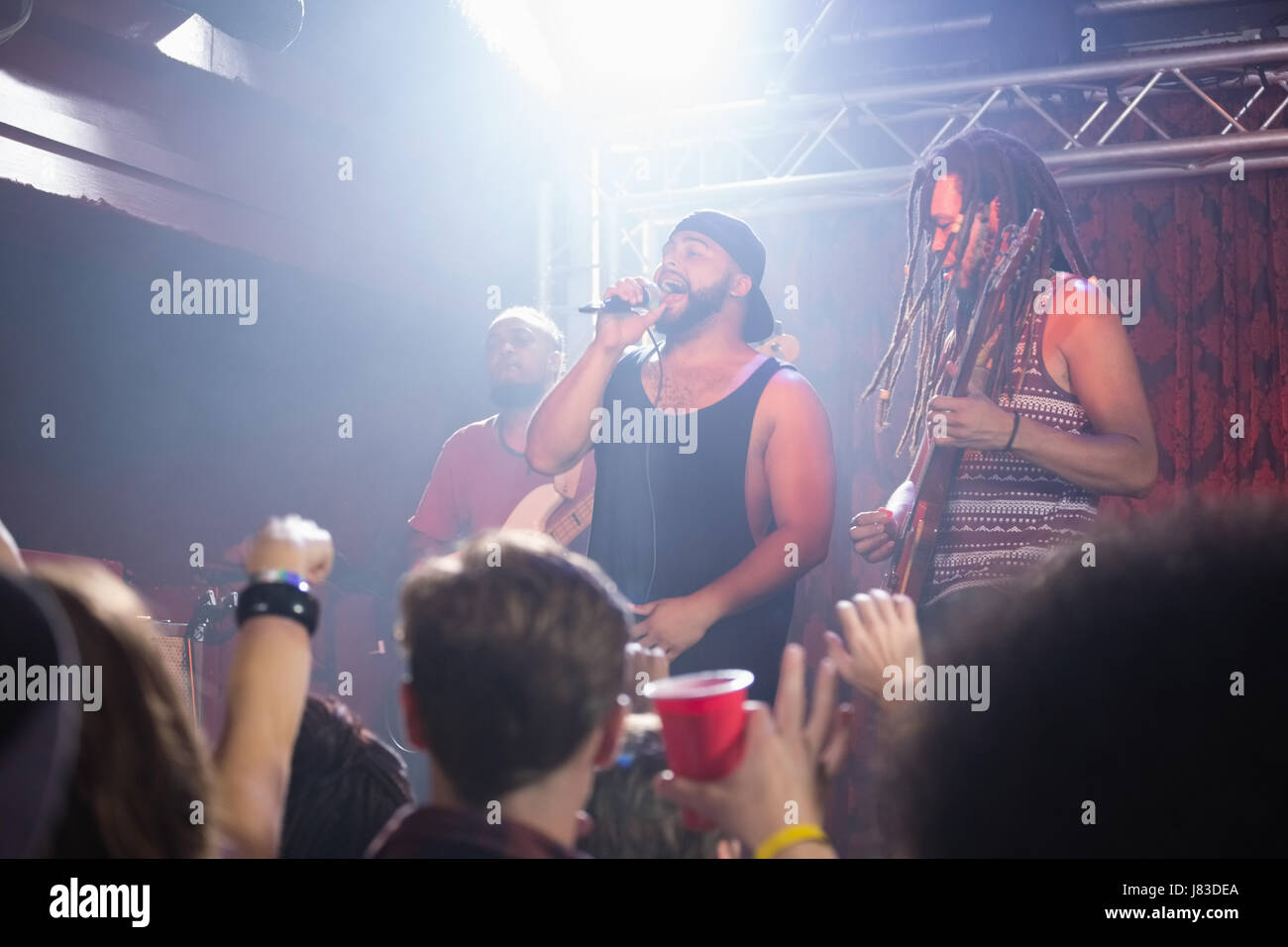 Singer performing on stage in nightclub Stock Photo - Alamy