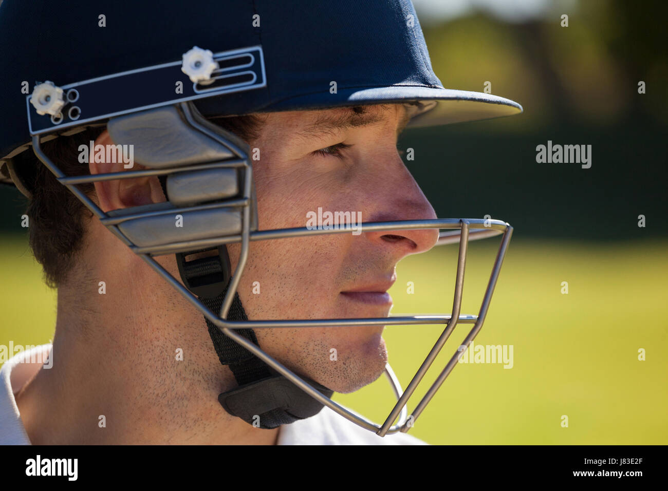 Close up of cricketer wearing helmet while playing at field Stock Photo ...