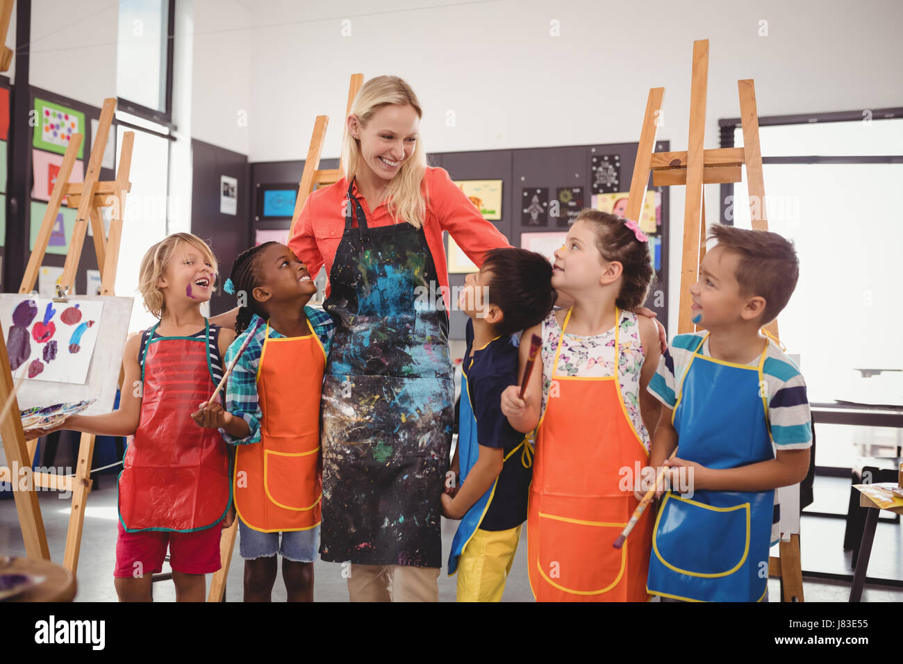 Teacher and schoolkids having fun in drawing class Stock Photo - Alamy