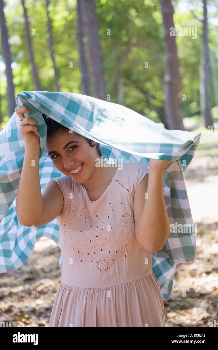 Portrait of woman standing under blanket in the park Stock Photo - Alamy