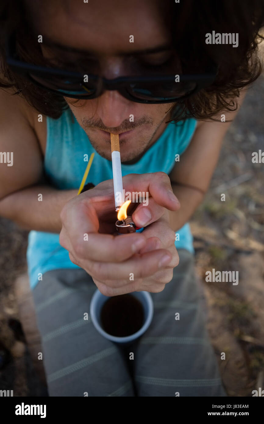 Drunken man smoking cigarette in the park Stock Photo - Alamy