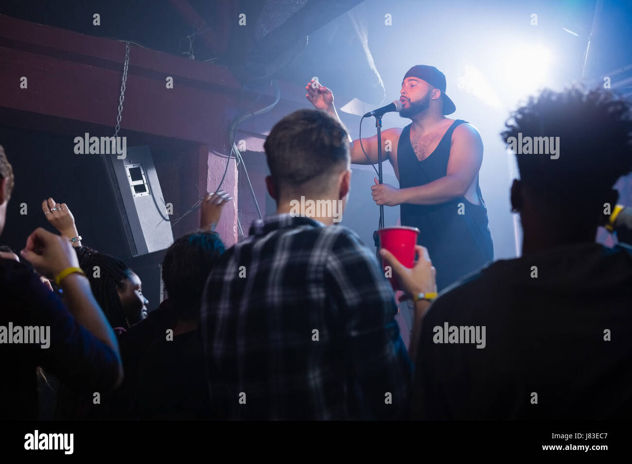 Singer performing on stage in nightclub Stock Photo - Alamy