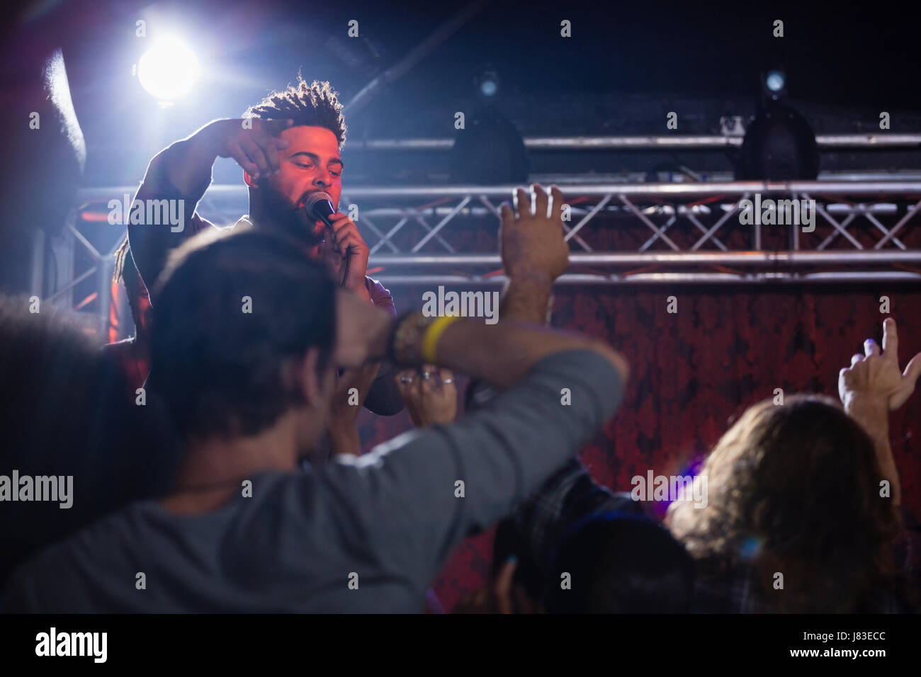 Singer performing on stage in nightclub Stock Photo - Alamy