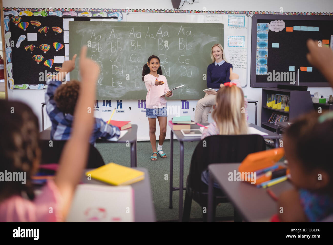 Boy taking book classroom hi-res stock photography and images - Alamy