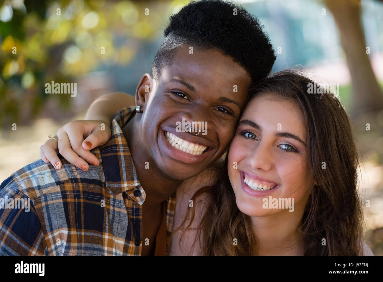 Portrait of couple posing together in the park Stock Photo - Alamy
