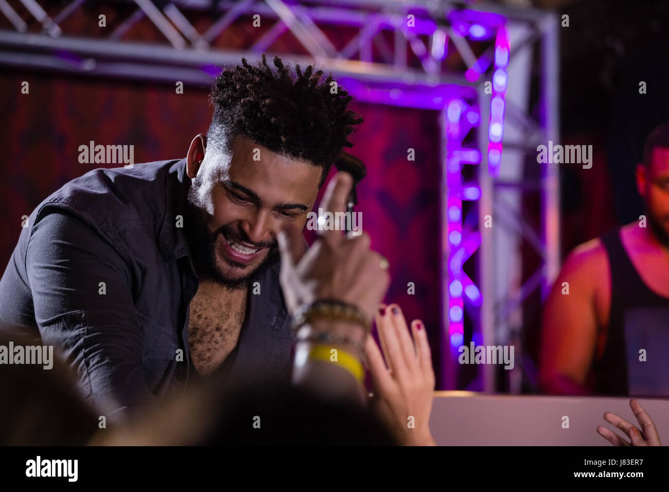 Singer performing on stage in nightclub Stock Photo - Alamy