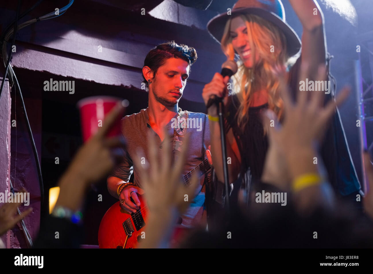 Singer performing on stage in nightclub Stock Photo - Alamy
