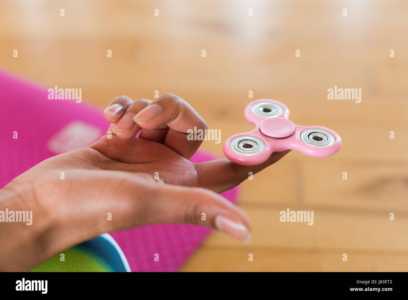 Girl holding a fidget spinner in a fitness room Stock Photo - Alamy