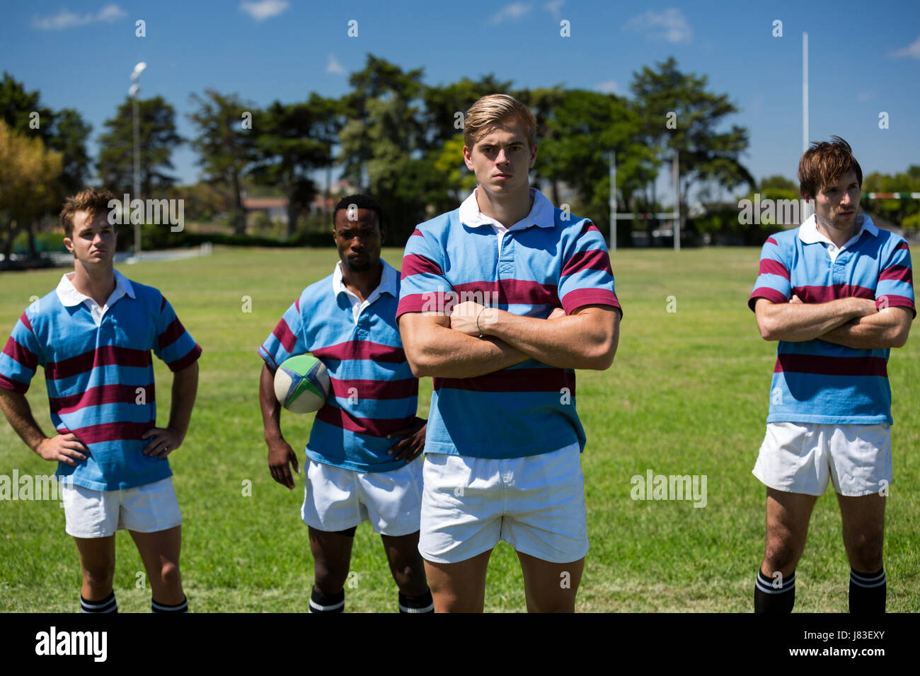 Portrait of confident rugby players standing on grassy field Stock ...