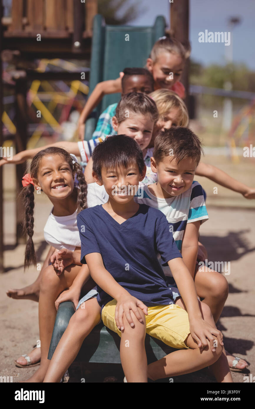 Happy schoolkids playing in playground of school Stock Photo - Alamy