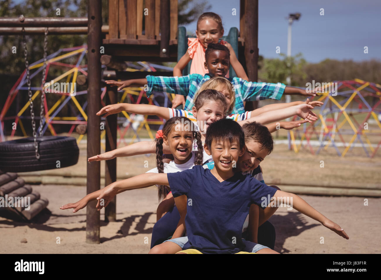 Happy schoolkids playing in playground of school Stock Photo - Alamy