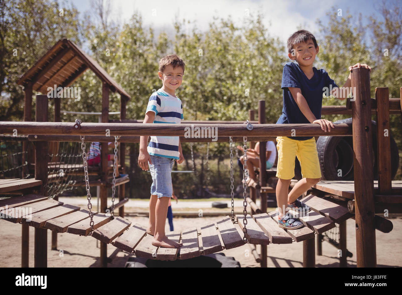 Happy schoolkids playing in playground of school Stock Photo - Alamy