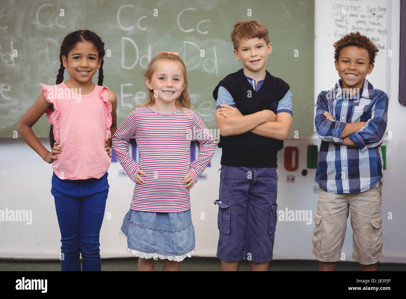 Portrait of smiling schoolkid standing in classroom at school Stock ...