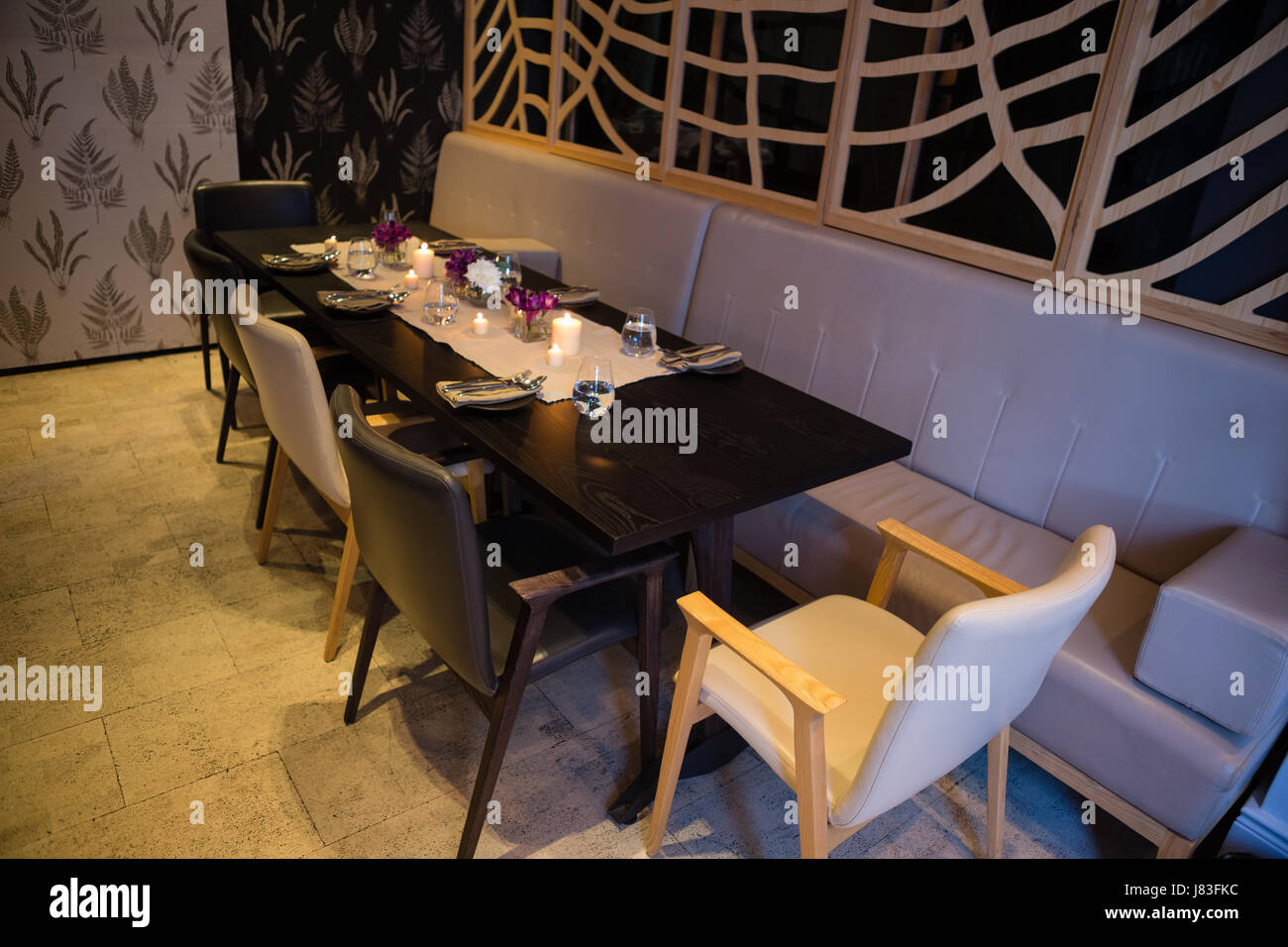 High angle view of empty dining table in illuminated restaurant Stock ...