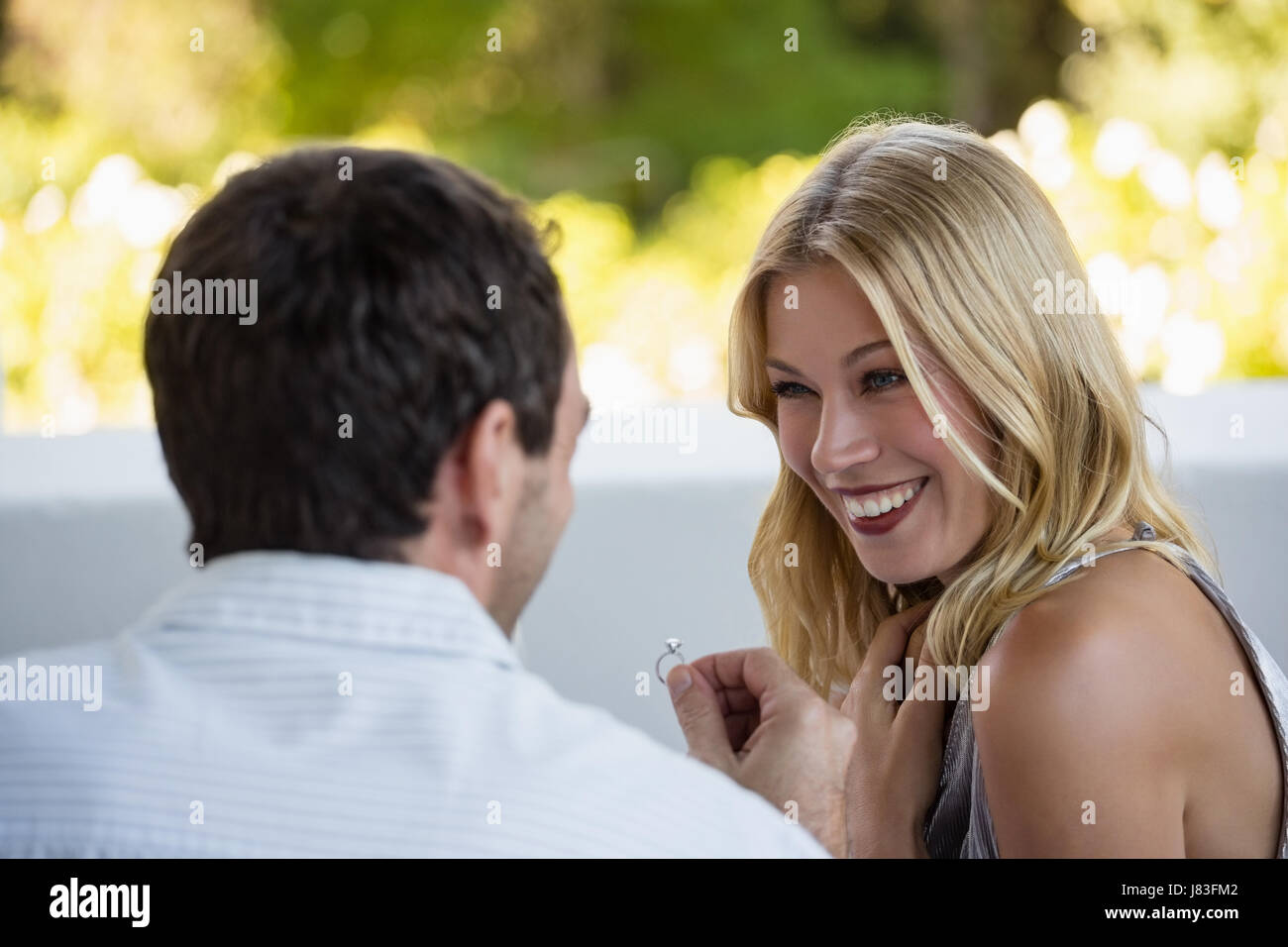 Rear view of man proposing his girlfriend at restaurant Stock Photo - Alamy