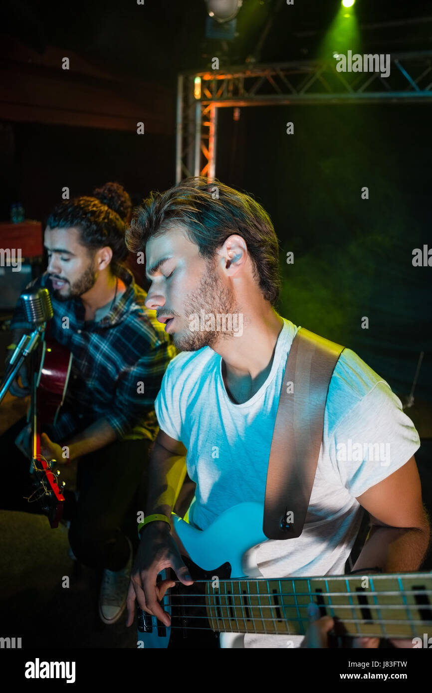 Band performing on stage in nightclub Stock Photo - Alamy