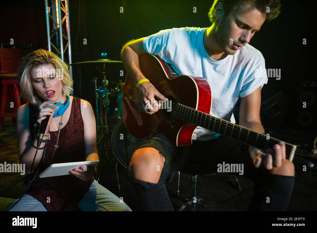 Female singer singing on vintage microphone in nightclub Stock Photo ...