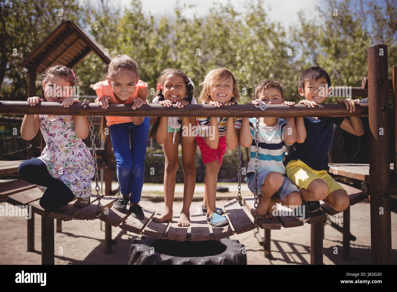 Portrait of happy schoolkids playing in playground of school Stock ...