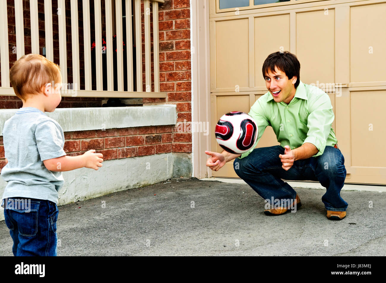Father son playing football catch hi-res stock photography and images ...