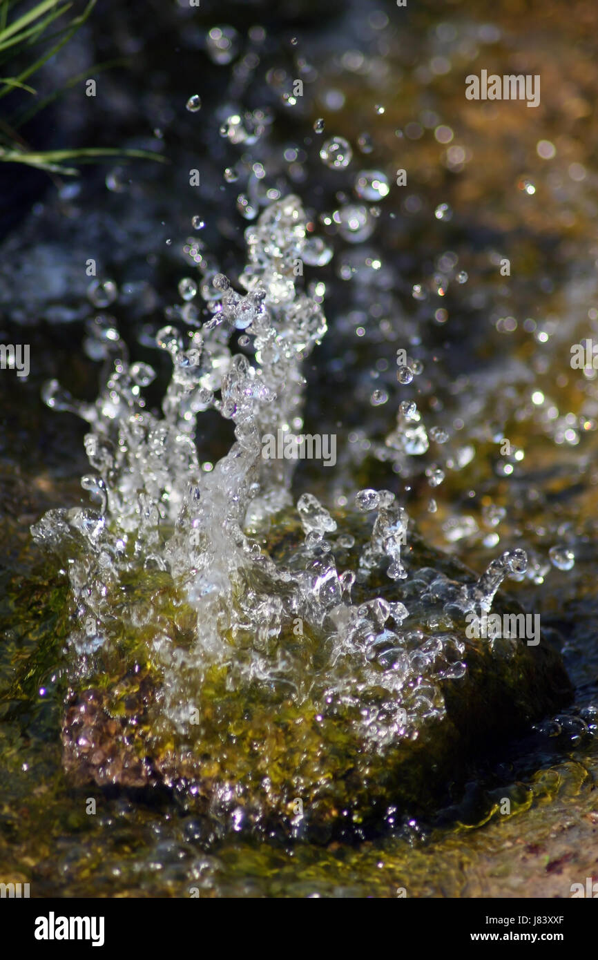 water breaks against a rock Stock Photo - Alamy
