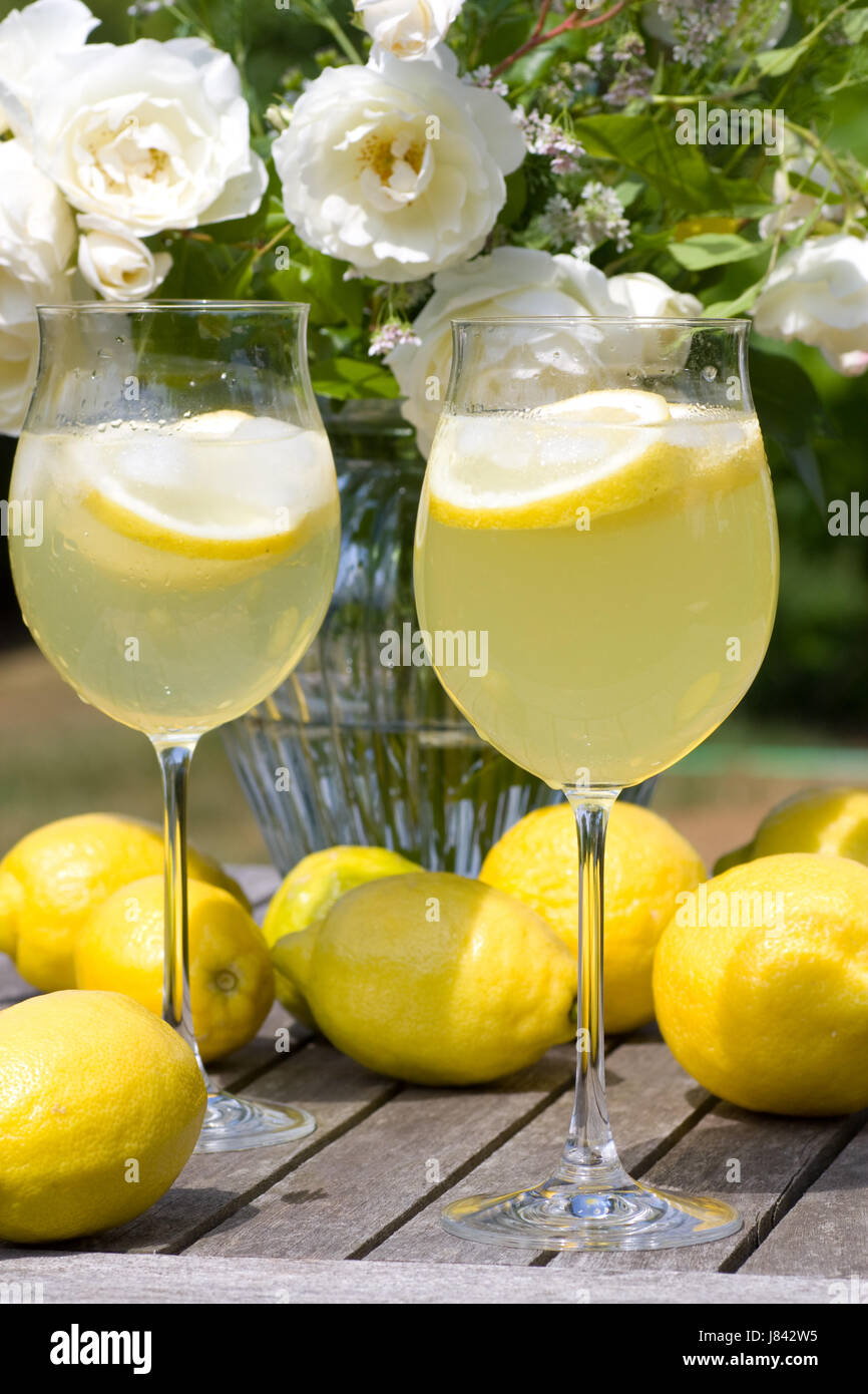 cocktails with lemons in the garden Stock Photo - Alamy