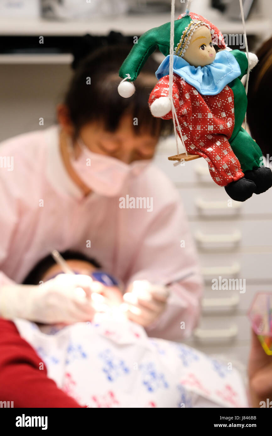 A young Asian boy got his teeth cleaned by a female dentist Stock Photo ...
