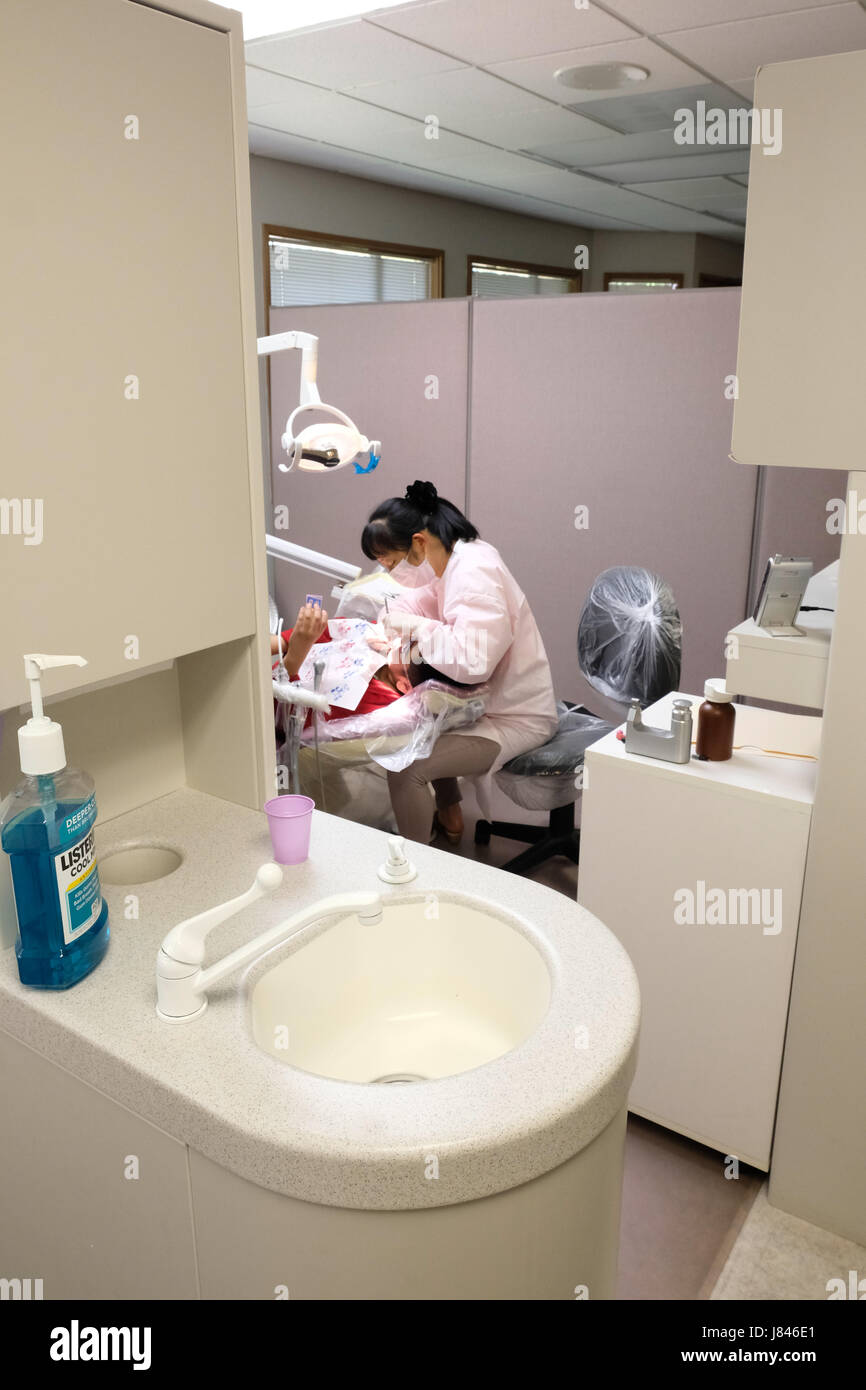 A young Asian boy got his teeth cleaned by a female dentist Stock Photo ...
