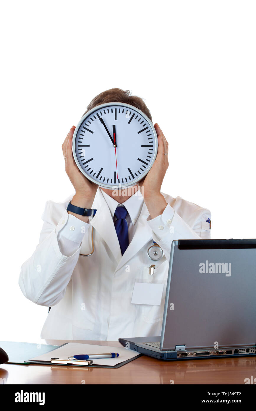 stressed doctor holds clock in front of face as sign of time pressure ...