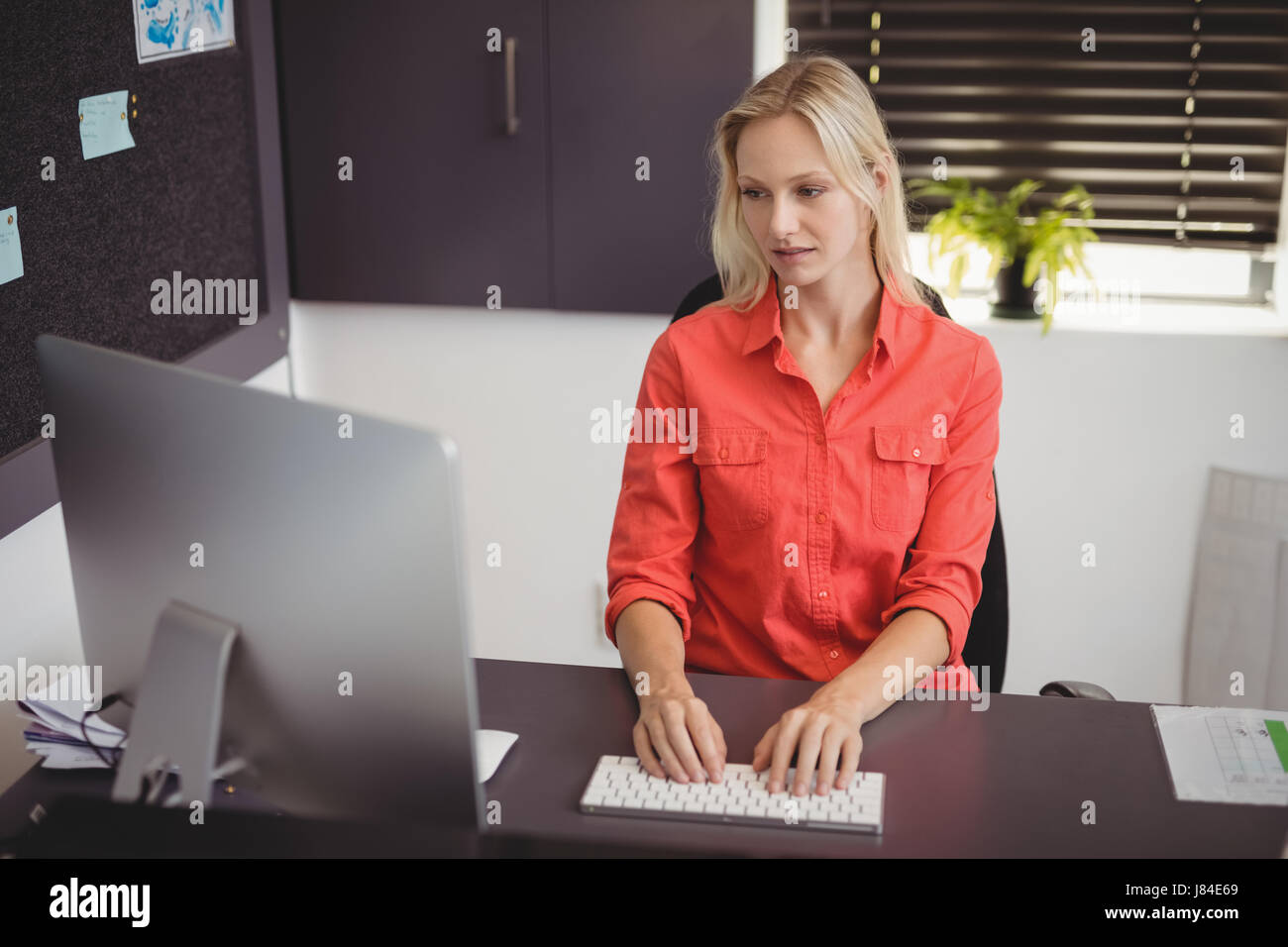 Teacher working on personal computer at desk in school Stock Photo - Alamy