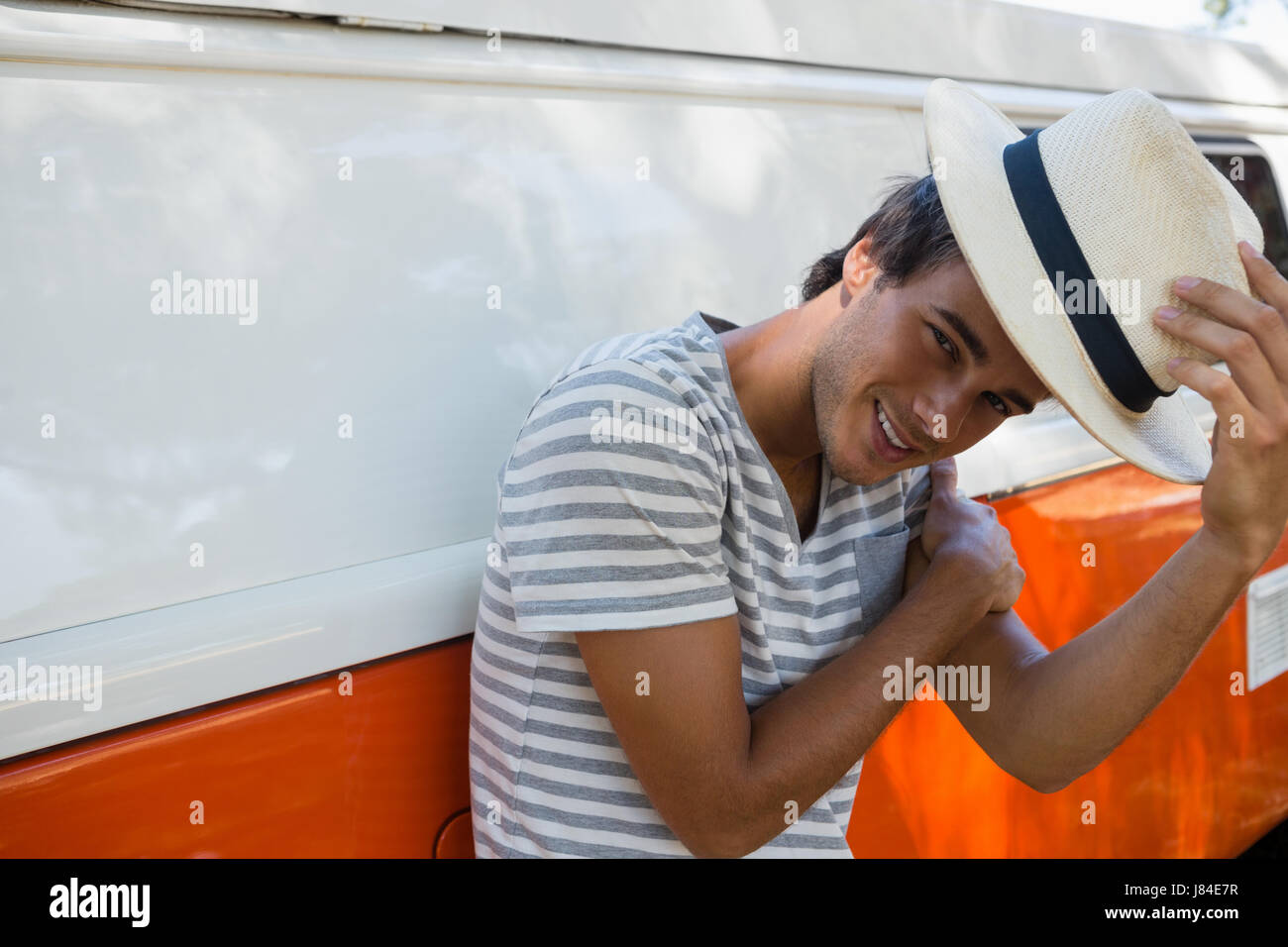 Portrait of man leaning on camper van in the park Stock Photo - Alamy
