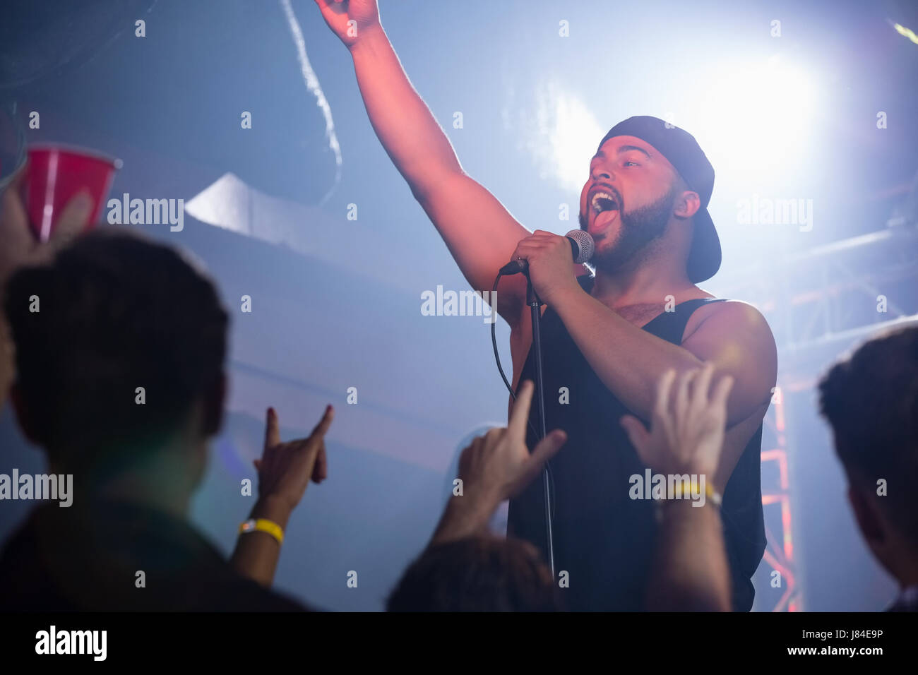 Singer performing on stage in nightclub Stock Photo - Alamy