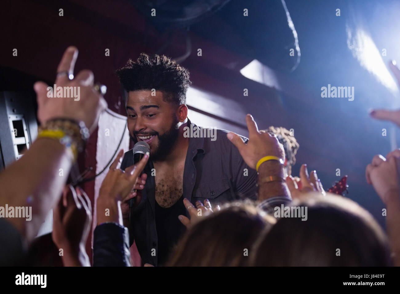 Singer performing on stage in nightclub Stock Photo - Alamy