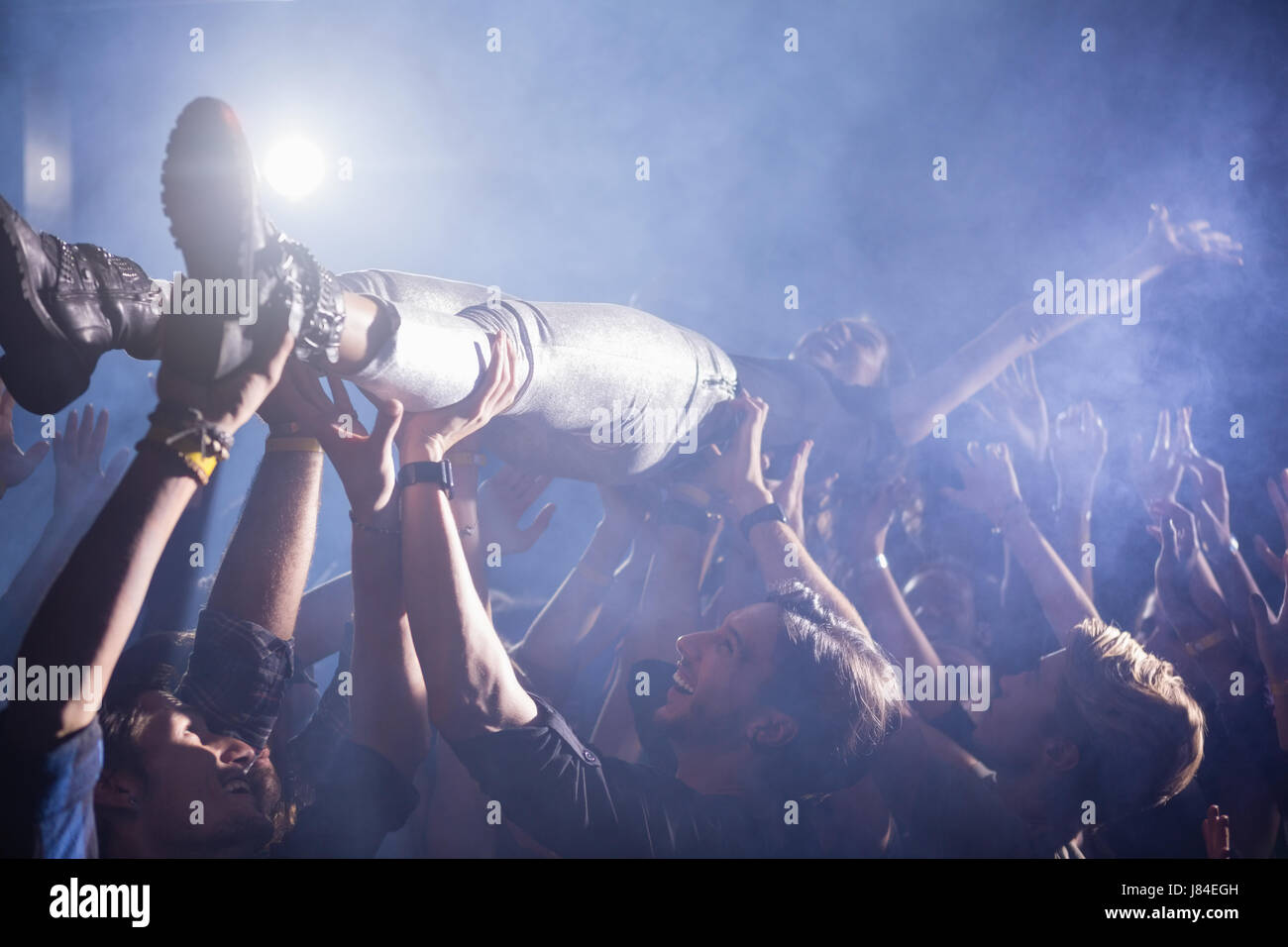 Crowd surfing at a concert in nightclub Stock Photo - Alamy
