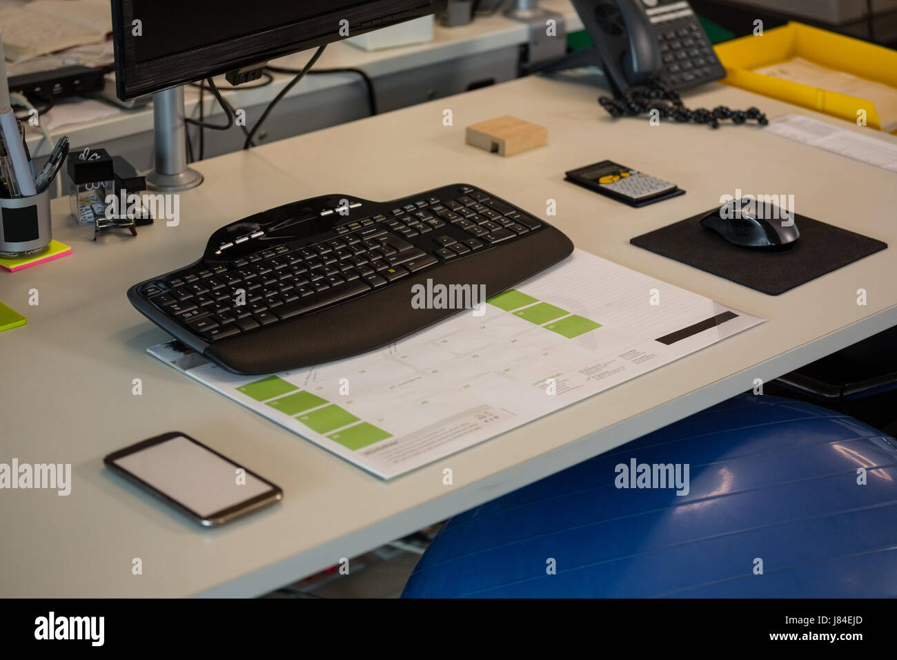 Fitness ball at desk in office Stock Photo - Alamy